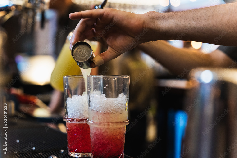 bartender pouring drinks from mixer Stock Photo | Adobe Stock