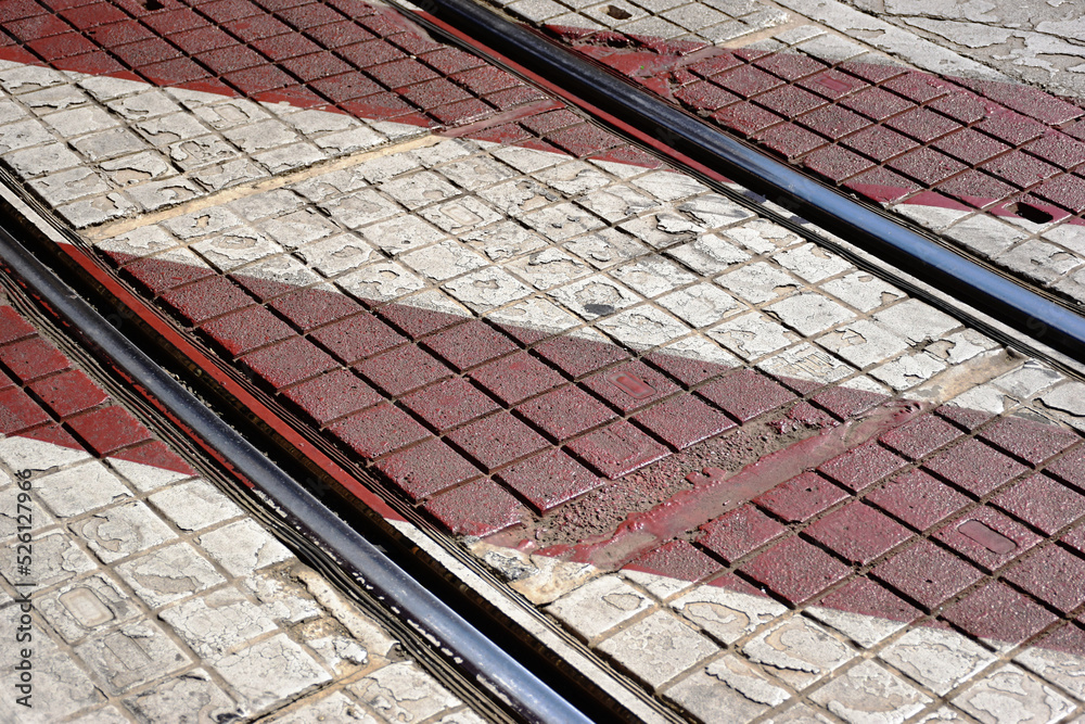 steel streetcar rails in urban setting with pedestrian crossing painted ...