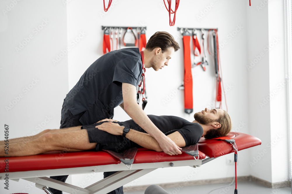 Rehabilitation specialist preparing for an active treatment on ...