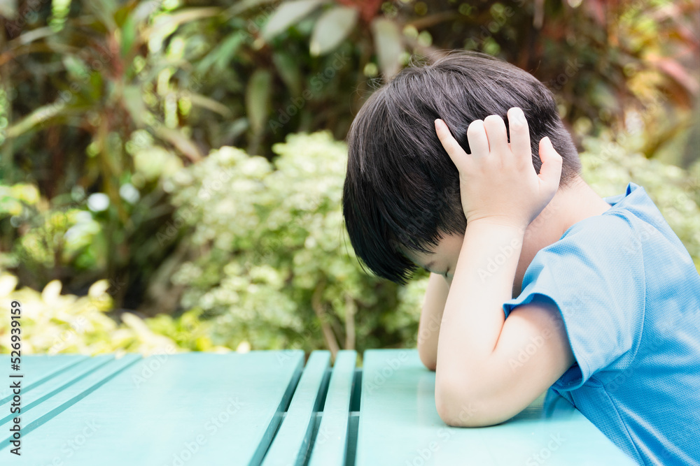 Close up of Asian autistic student child sit at table at school cover ...