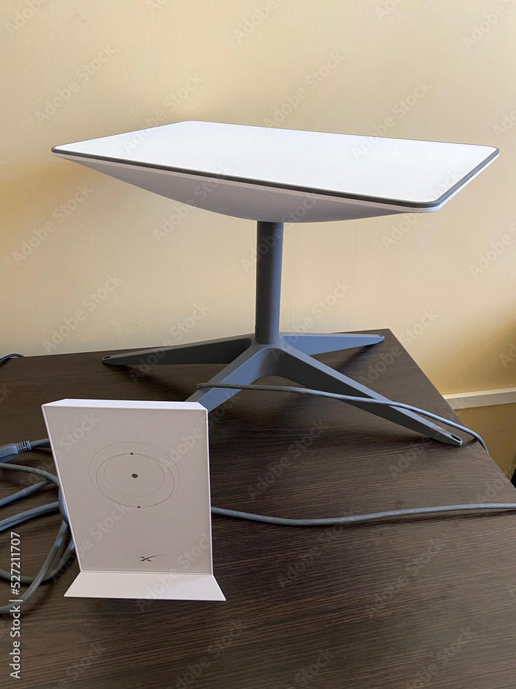 Starlink space signal receiver in the table in office. Starlink is a ...
