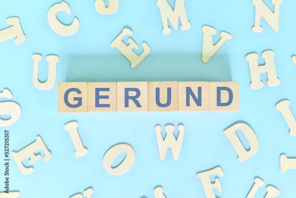 Gerund concept in English grammar and learning class lesson. Wooden ...