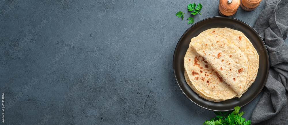 Chapati, traditional tortillas with fresh parsley on a graphite ...