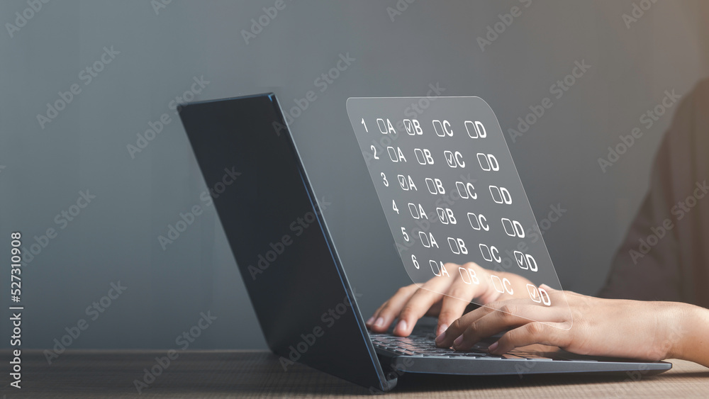 Students taking online exams by laptop. Virtual test or questionnaire ...