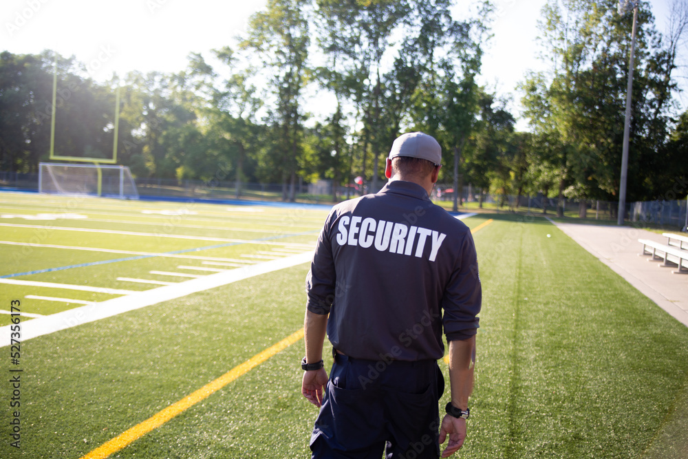 Security guard patrolling soccer stadium Stock Photo | Adobe Stock