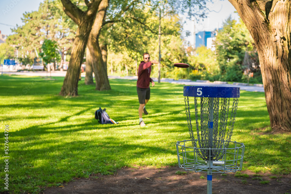 Disc golf, a flying disc sport played using rules like golf, being ...