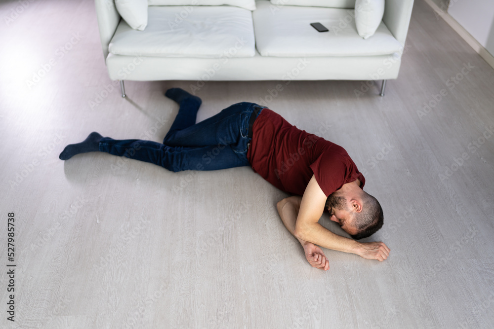 Unconscious Young Man Lying On Floor Stock Photo | Adobe Stock