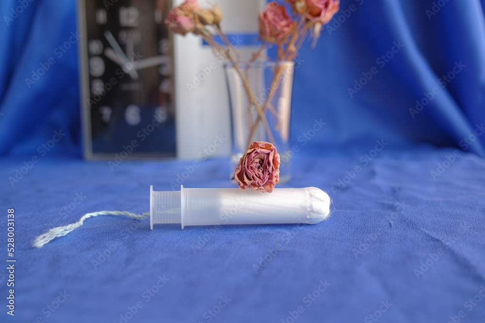 menopause concept. dried red rose lies on a woman tampon. dried rose ...