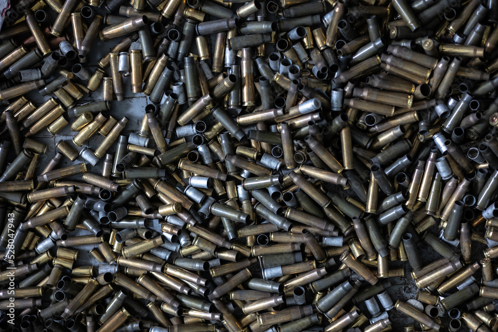 on the floor in the shooting range there are casings from fired ...