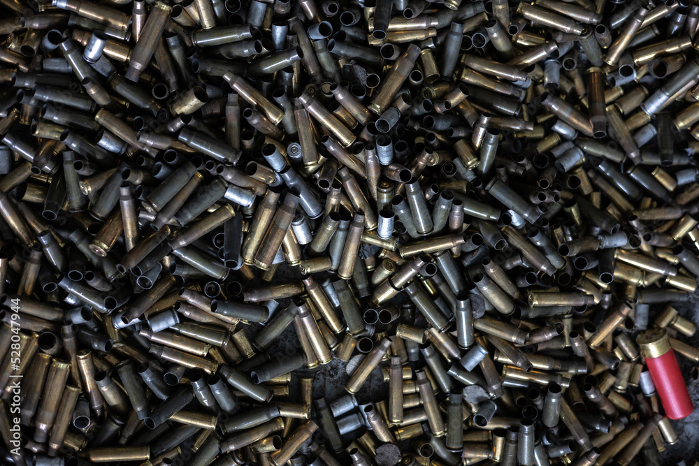 on the floor in the shooting range there are casings from fired ...