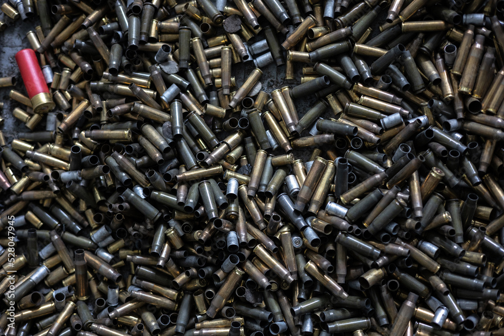on the floor in the shooting range there are casings from fired ...