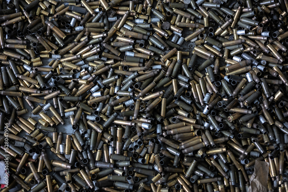 on the floor in the shooting range there are casings from fired ...