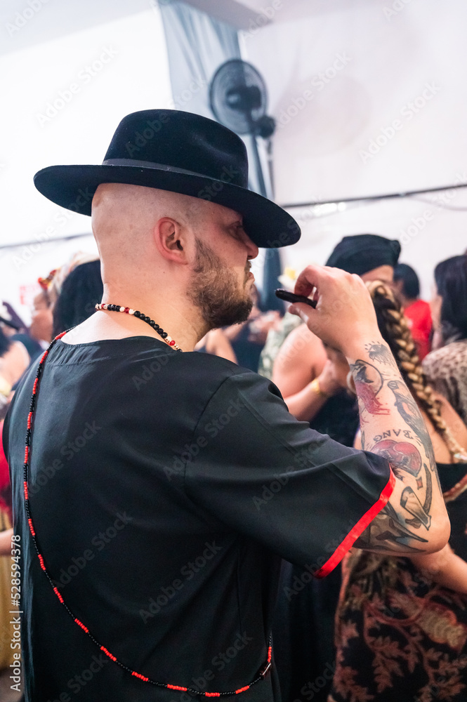 man incorporated with exu smoking cigar in ritual of Brazilian religion ...