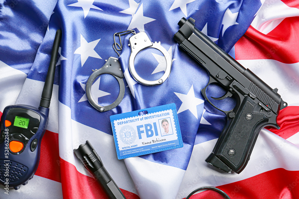 Document of FBI agent with gun, handcuffs, portable radio transmitter ...