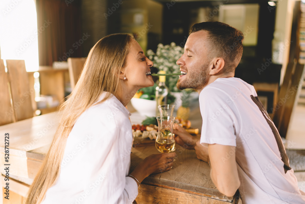 Happy Caucasian couple in love having fun during brunch meal at terrace ...