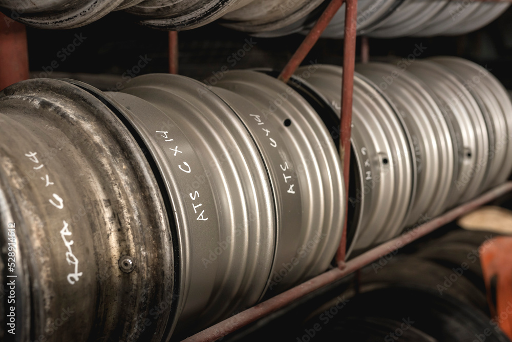 Spare labeled car rims stored at a warehouse at a auto repair shop ...