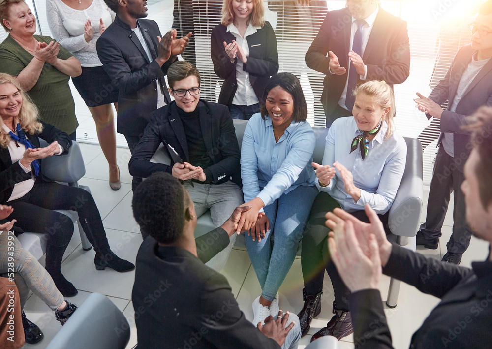 employees greeting their new colleague with applause. Stock Photo ...