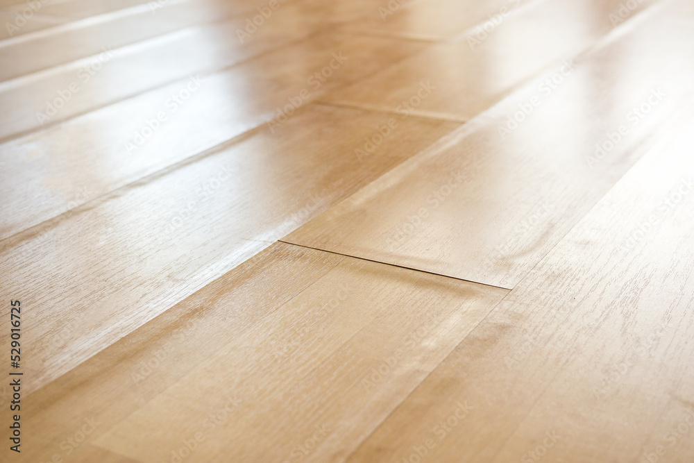 Swollen laminate flooring from flood or water damage, perspective view ...