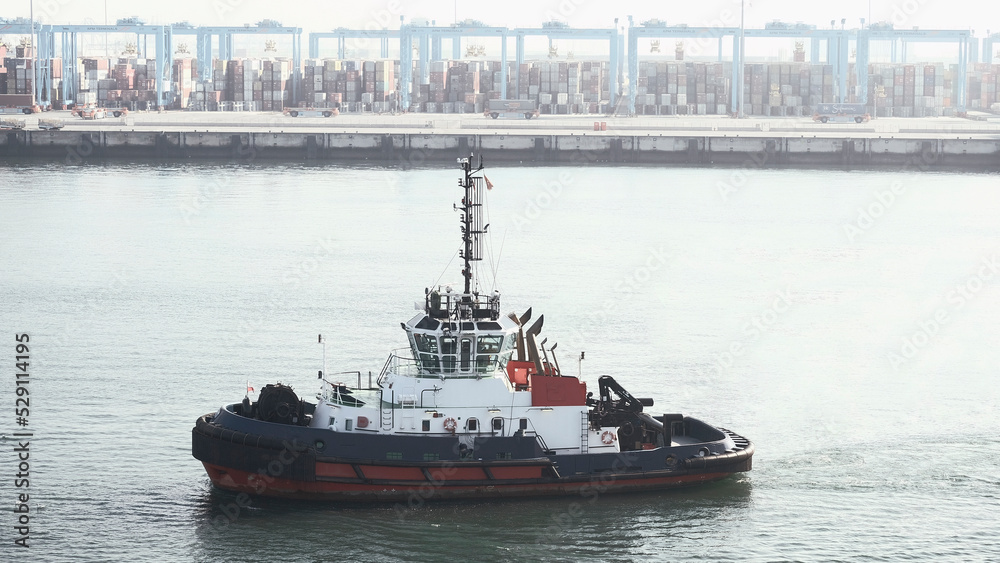 Side view of heavy-duty tug boat with a strong bollard pull underway ...