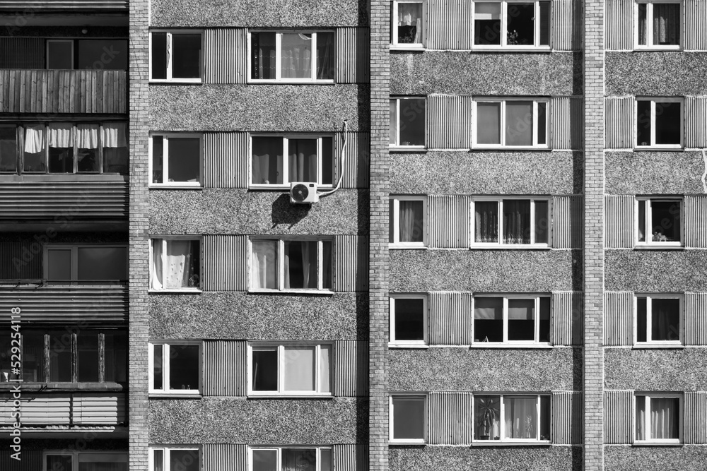 Background from the wall of a multi-story building. Old concrete house wall with windows ...