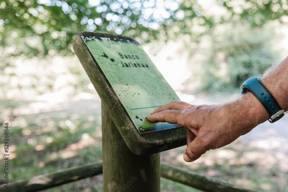 Blind tourist reading braille on signboard Stock Photo | Adobe Stock