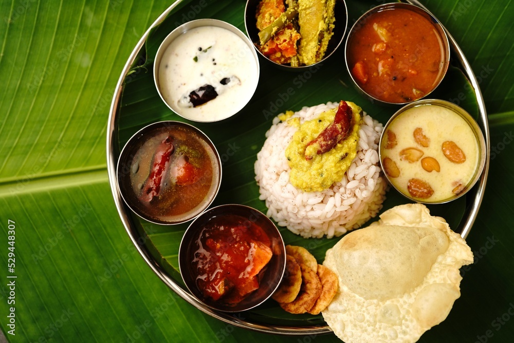Kerala Ona sadya Onam feast - vegetarian thali served on a round plate ...