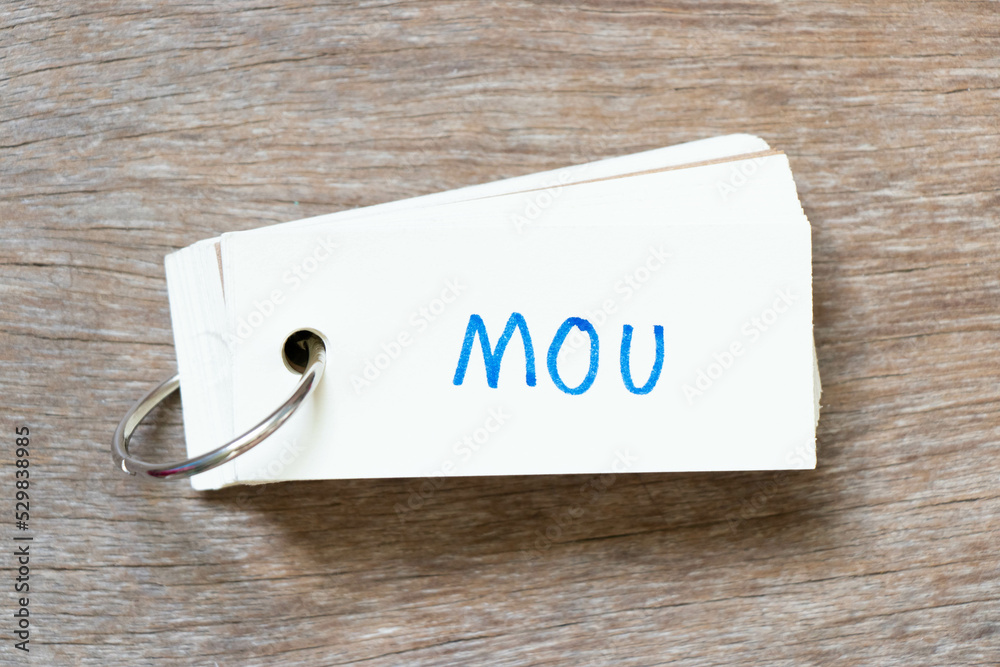Flash card with handwriting in word MOU (Abbreviation of memorandum of ...