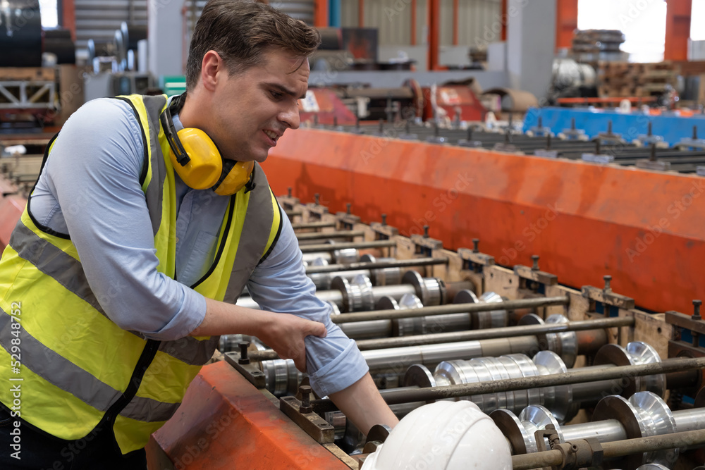 Men Caucasian engineer getting his hand stuck in industrial machine ...