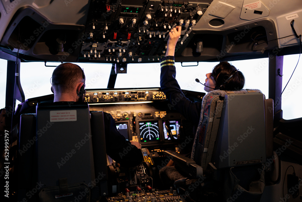 Aircrew members flying airplane with dashboard command, using control ...