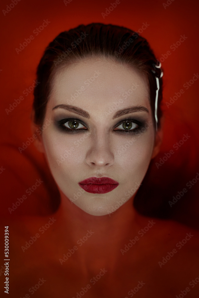 Portrait of a gothic vampire girl with pale skin in bloody water. Stock ...
