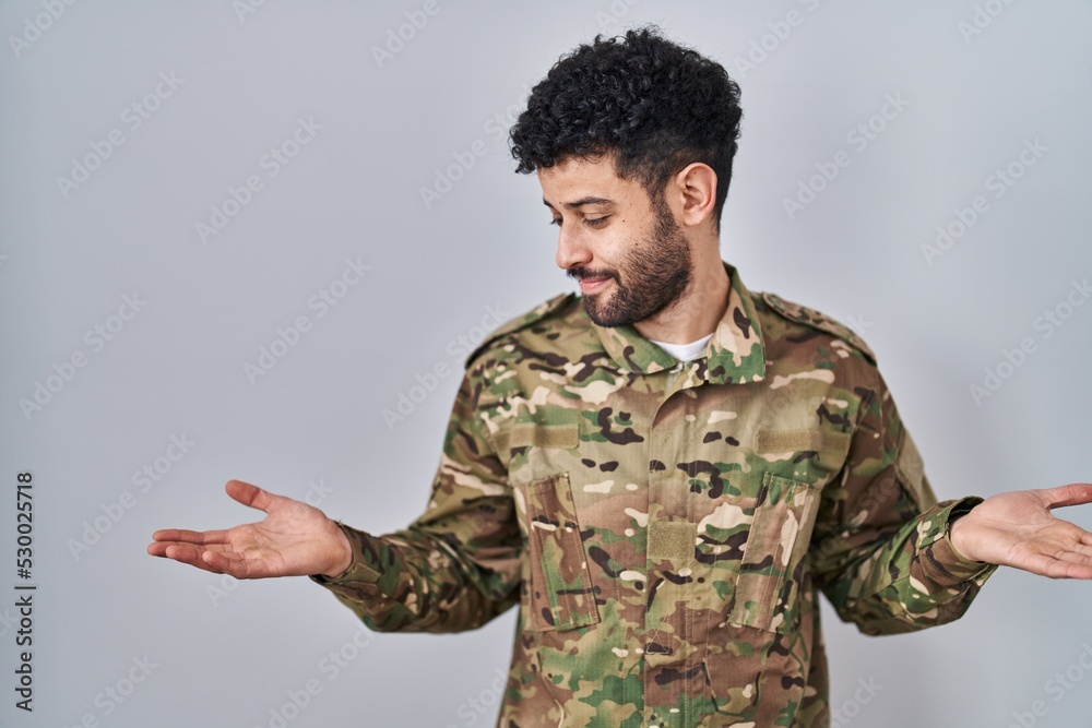 Arab man wearing camouflage army uniform smiling showing both hands ...