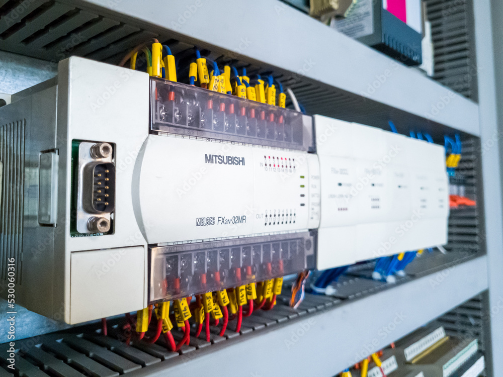 Mitsubishi PLC modules in a row in electrical cabinet of automation control system on industrial ...