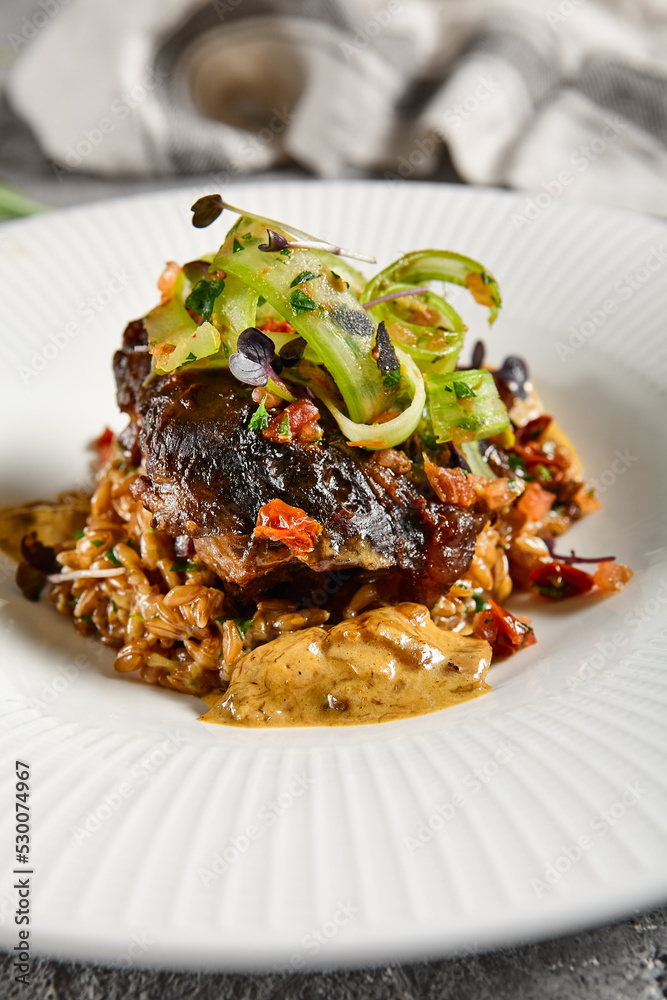 Braised beef cheeks with pearl barley and celery in creamy mushroom ...