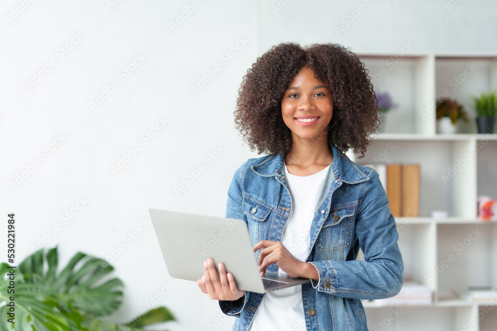 Smiling beautiful business woman happily and comfortably working on her ...