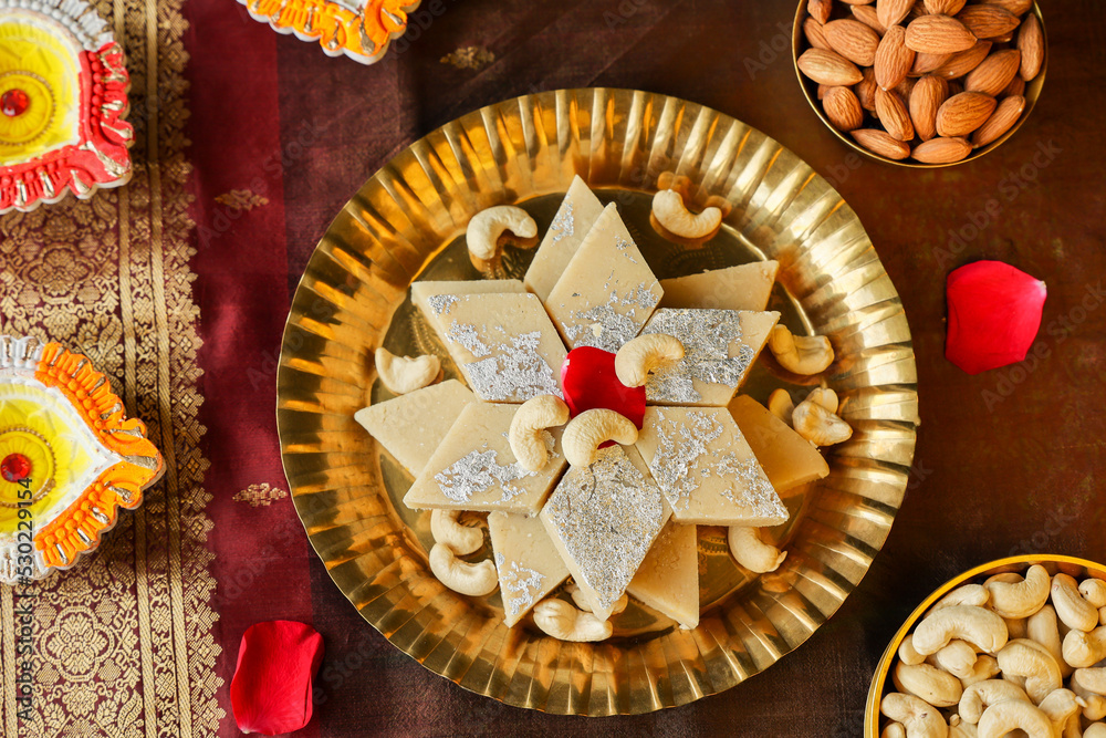 Kaju Katli Kaju Barfi Burfi cashew fudge candy woman hand serving ...