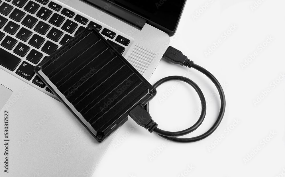 Foto de Stock An external USB hard disk drive isolated on a white ...