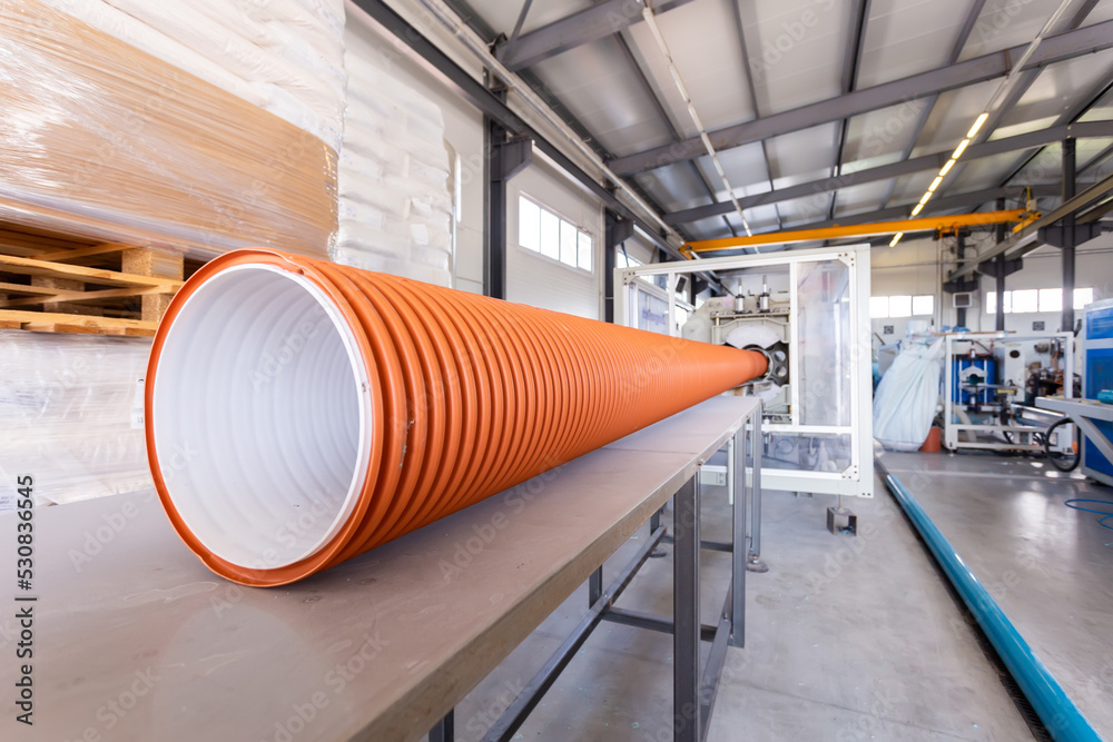 conveyor plastic pipe polymer production line Stock Photo | Adobe Stock