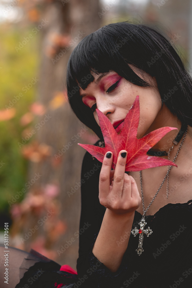 Young and skinny hispanic goth girl in the forest with black dress ...