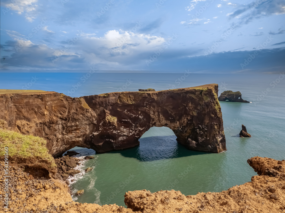 The iconic black sand beaches of Reynisfjara and the sea stacks ...