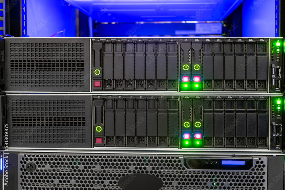 Computers with many hard drives are in the rack. The front panel of ...