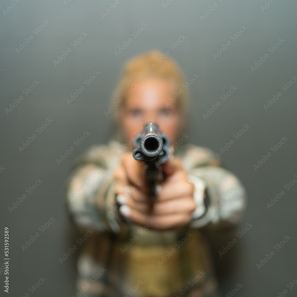 Girl takes aim from a classic 45 caliber revolver, front view, soft ...