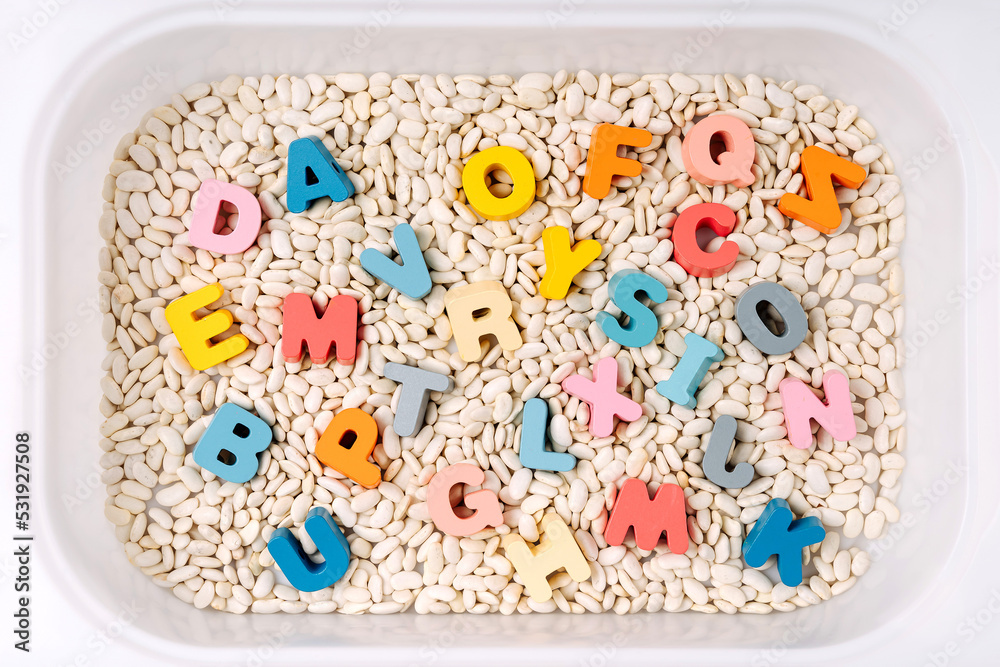 Colorful letters of the alphabet in sensory bin. Primary school or ...