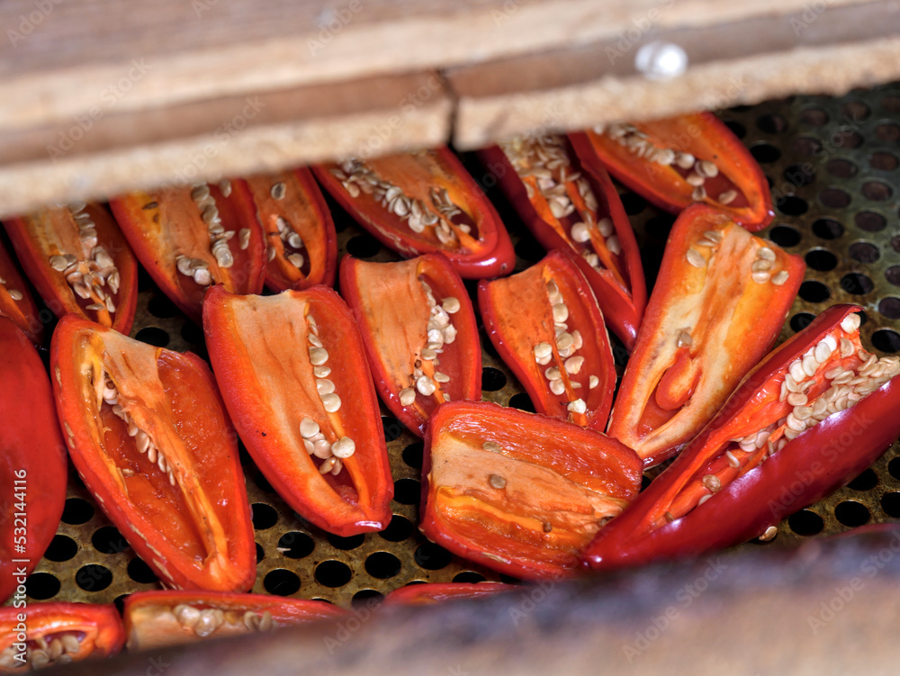 Cold smoking of jalapeno peppers, cut in half and placed on a grid of a ...