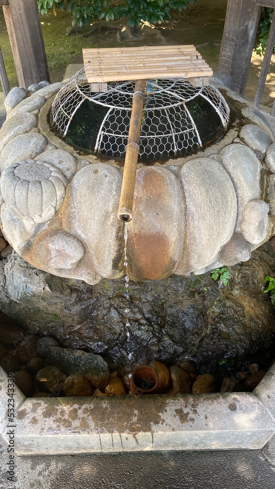 Hand washing fountain at the Japanese shrine, in shapes of the lotus ...