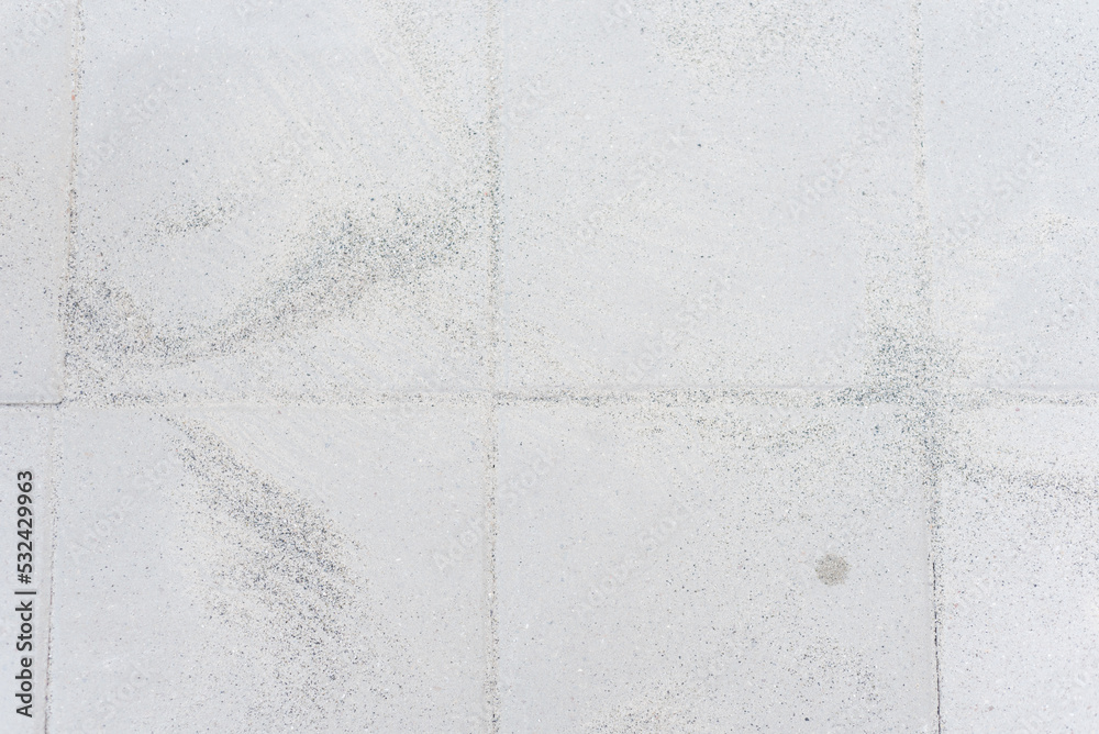 Polymeric paver sand on top of gray concrete patio stone paver brick ...