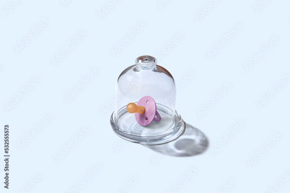 Baby pacifier lying under glass cover Stock Photo | Adobe Stock