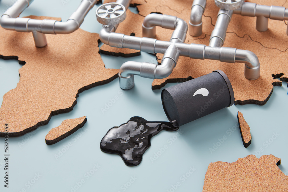 Piping over map with puddle of crude oil. Stock Photo | Adobe Stock