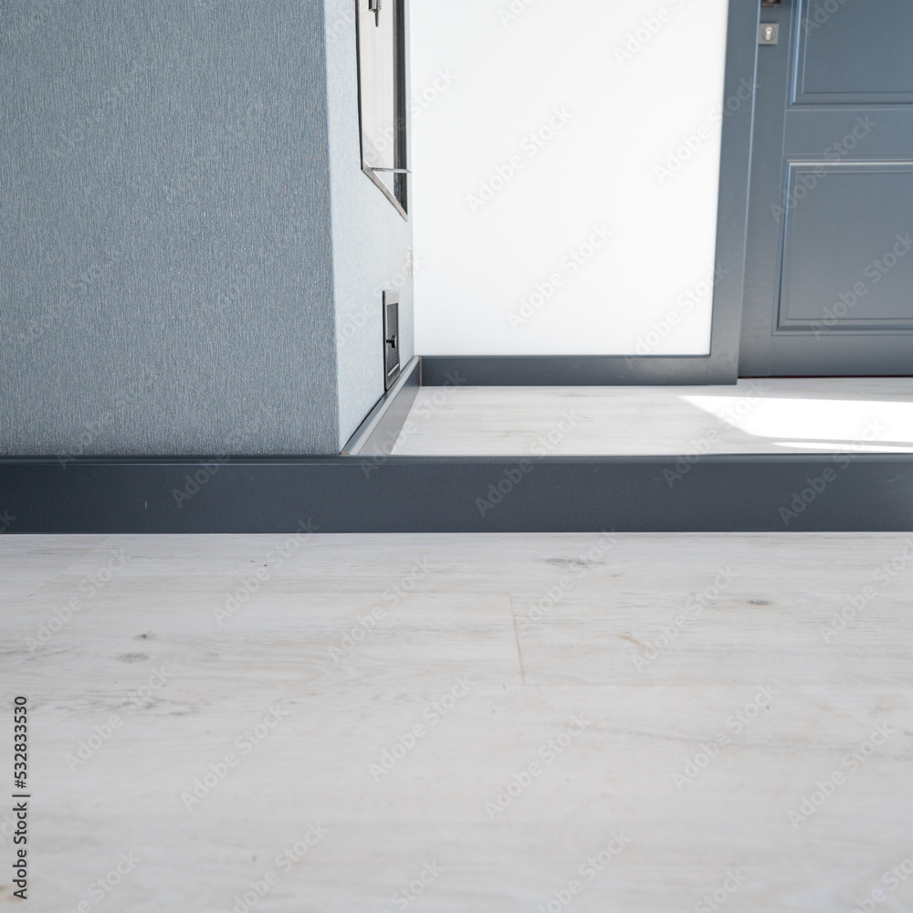 The plinth is dark gray to match the color of the door, mounting the ...