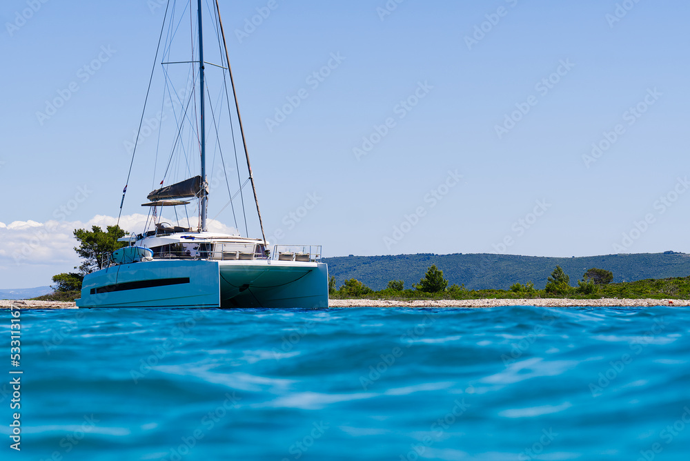 Catamaran sailing in ocean. paradise at sea. Blue sky and turquoise ...