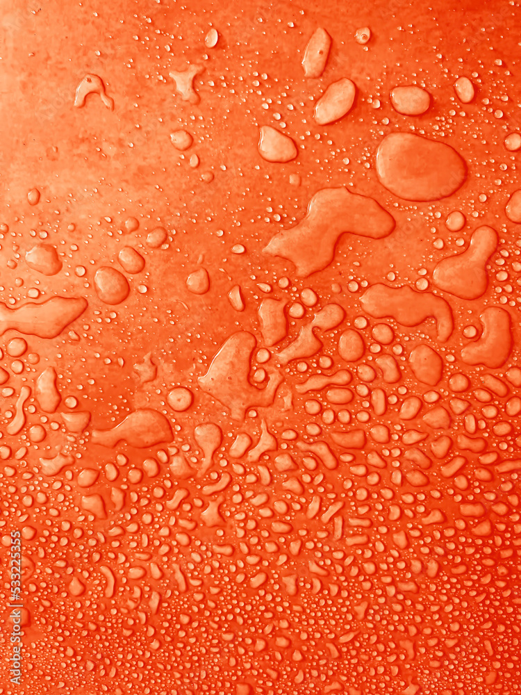 water drops of different sizes on a orange surface, drops texture, rain ...